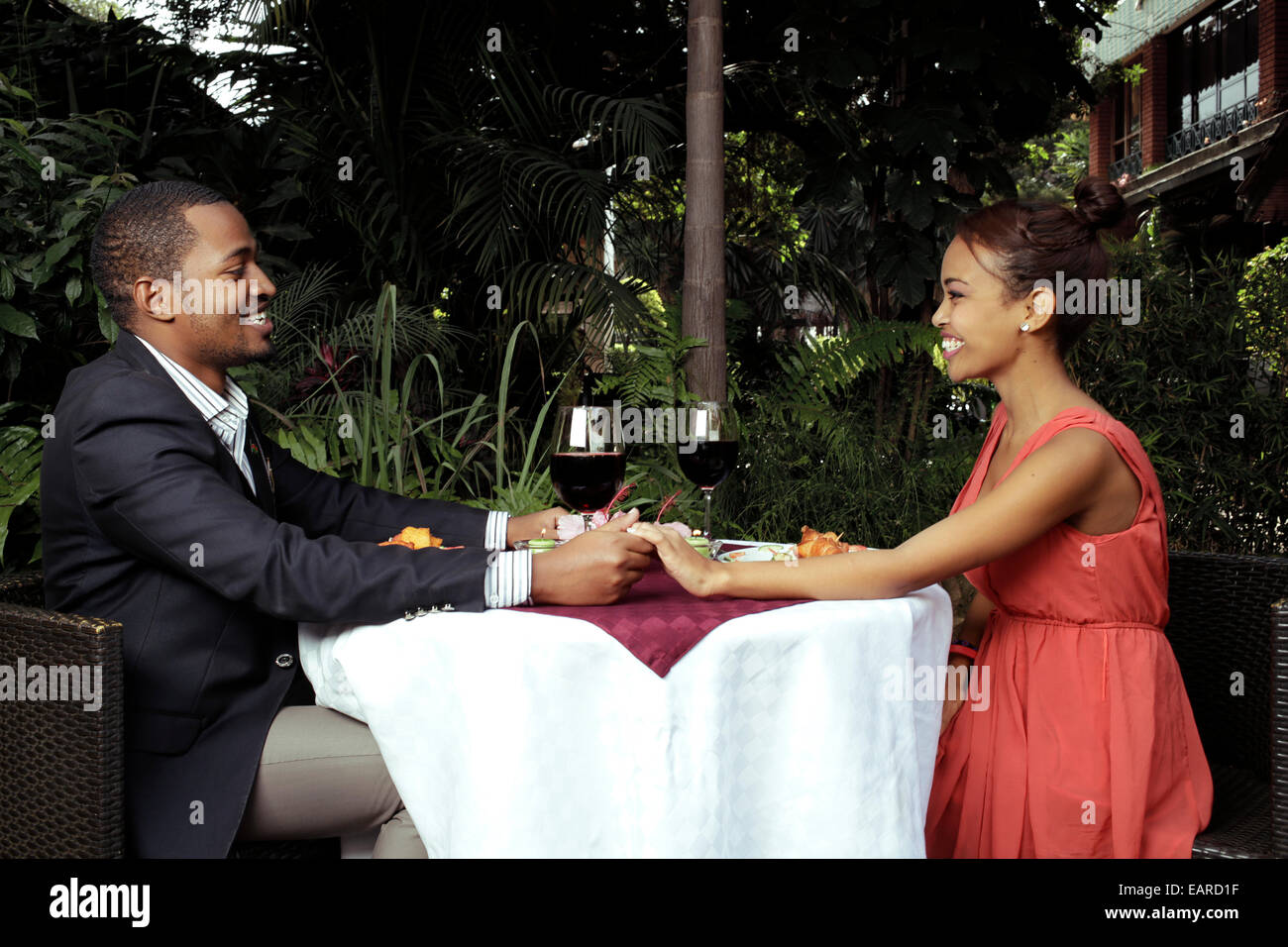 A young Kenyan couple enjoying a romantic dinner at a high class ...