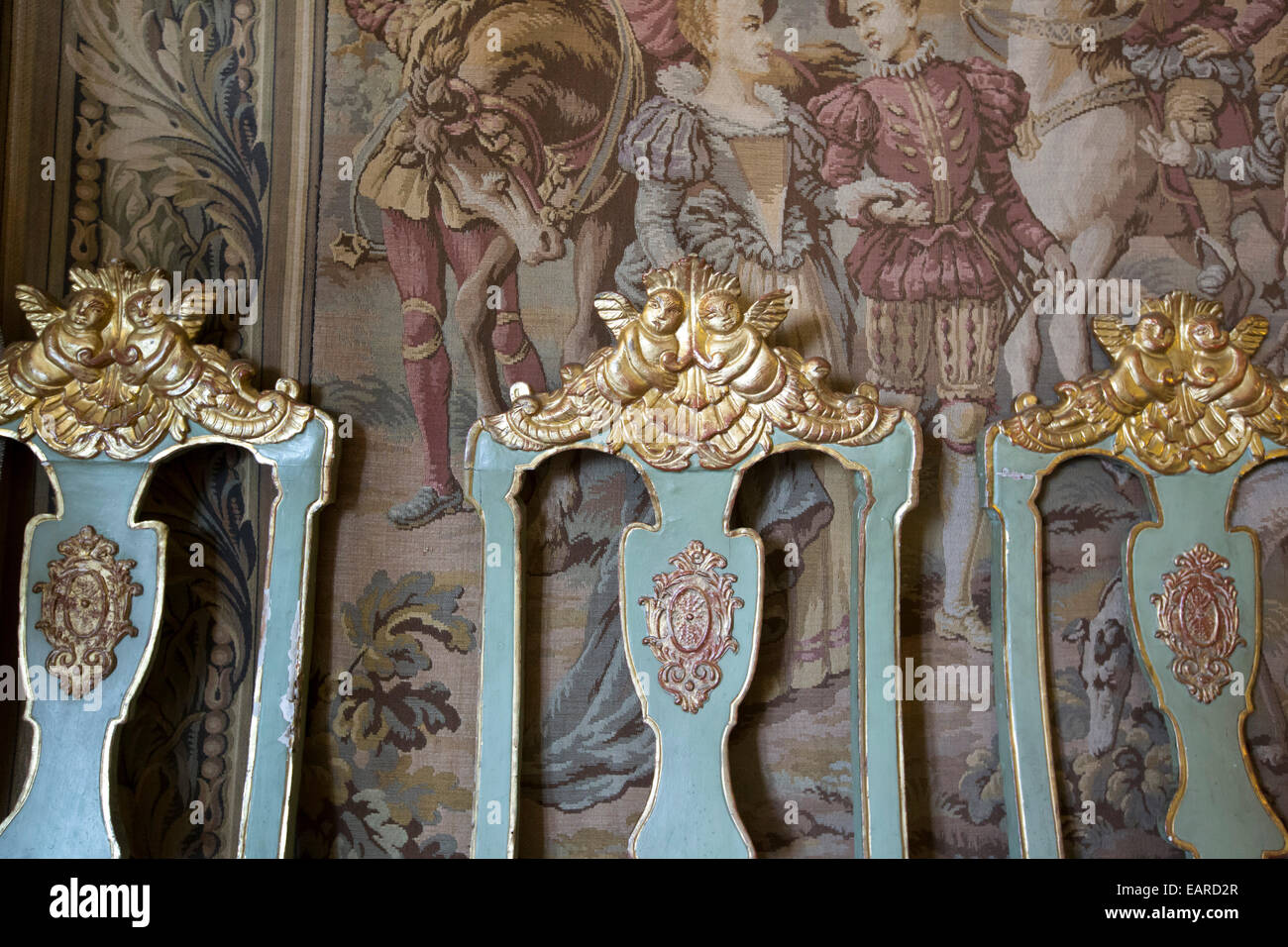 Old gold gilt chairs and a tapestry wall hanging at Bamburgh Castle in ...