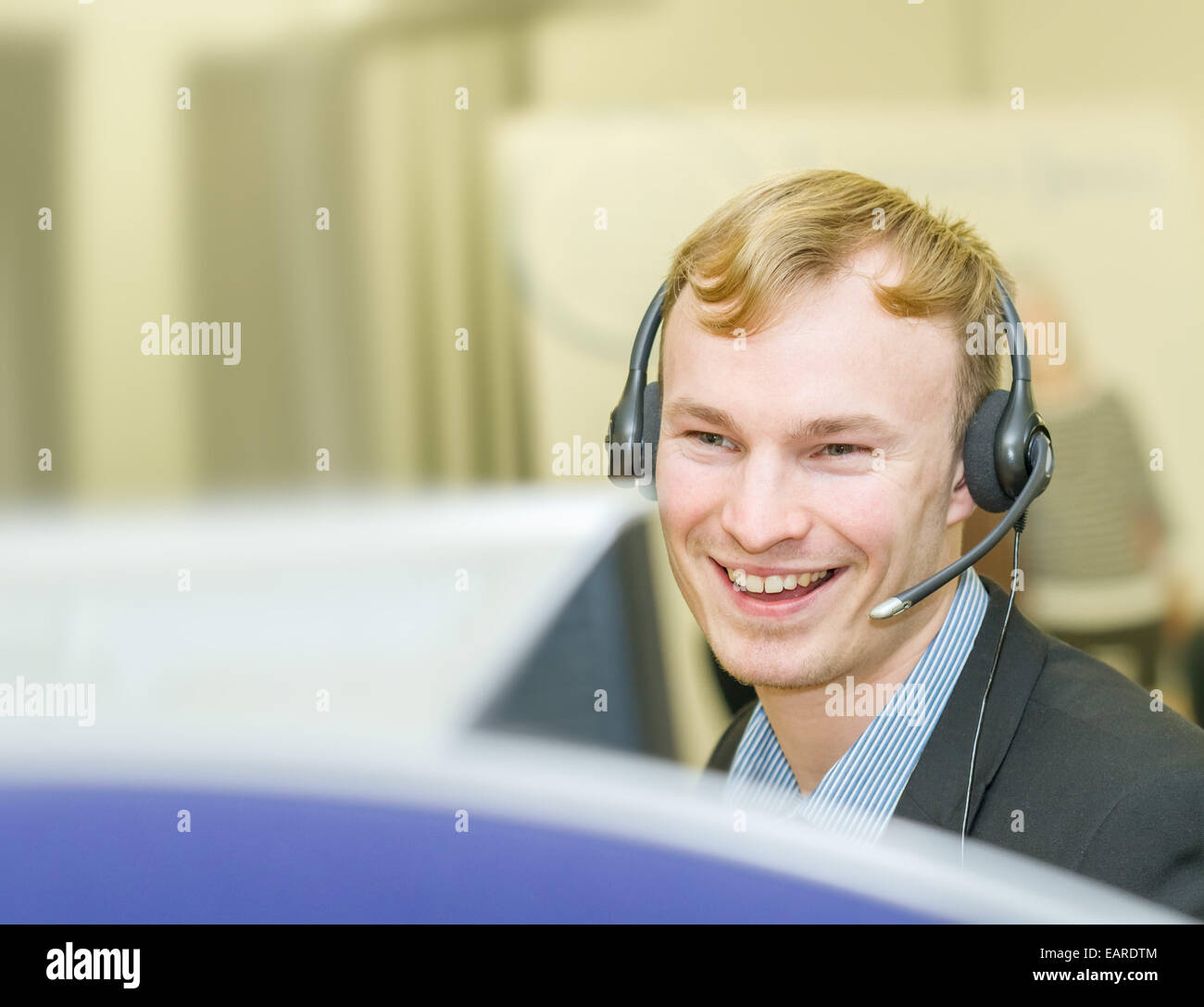 Call Centre staff - young blond man wearing an audio headset Stock ...