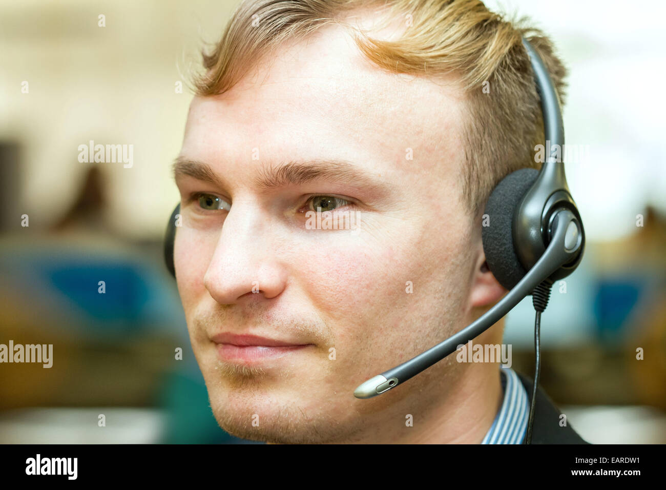 Call Centre staff - young blond man wearing an audio headset Stock ...