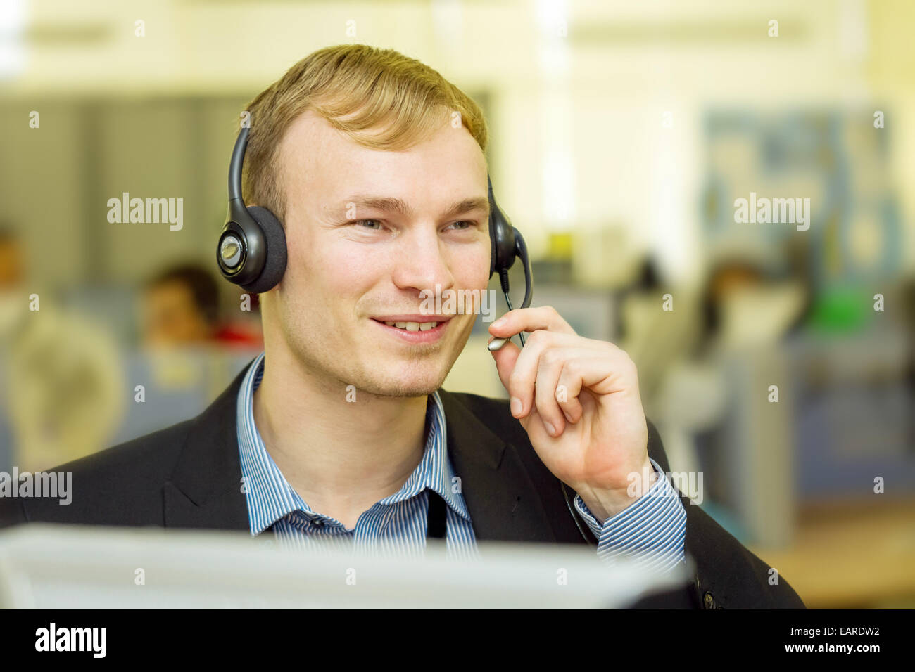 Call Centre staff - young blond man wearing an audio headset Stock ...