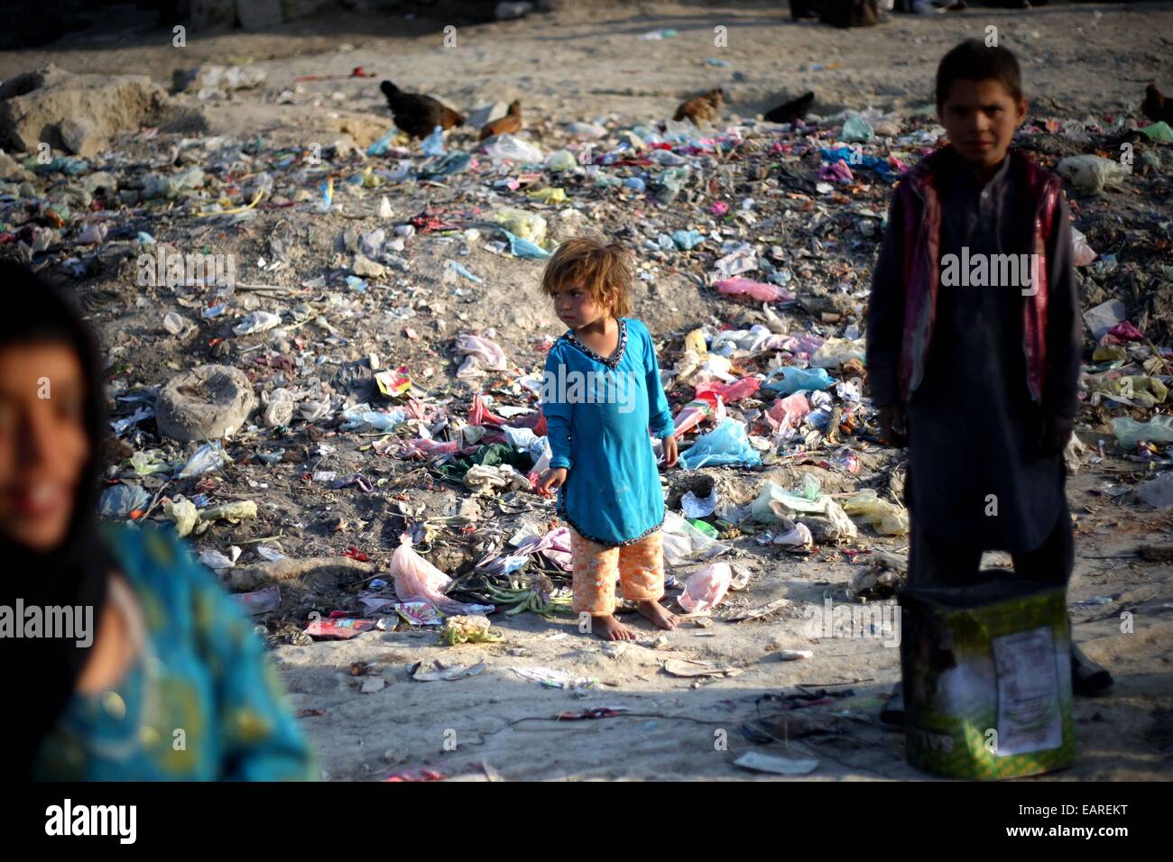 Kabul, Afghanistan. 19th Nov, 2014. A child stands on the garbage at a ...