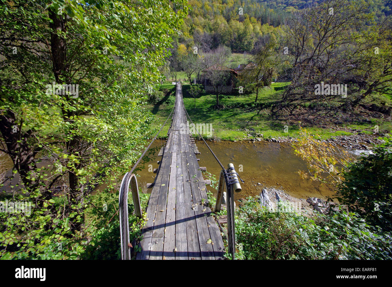 Small rope bridge over mountain river. Connection with the world. Tube ...