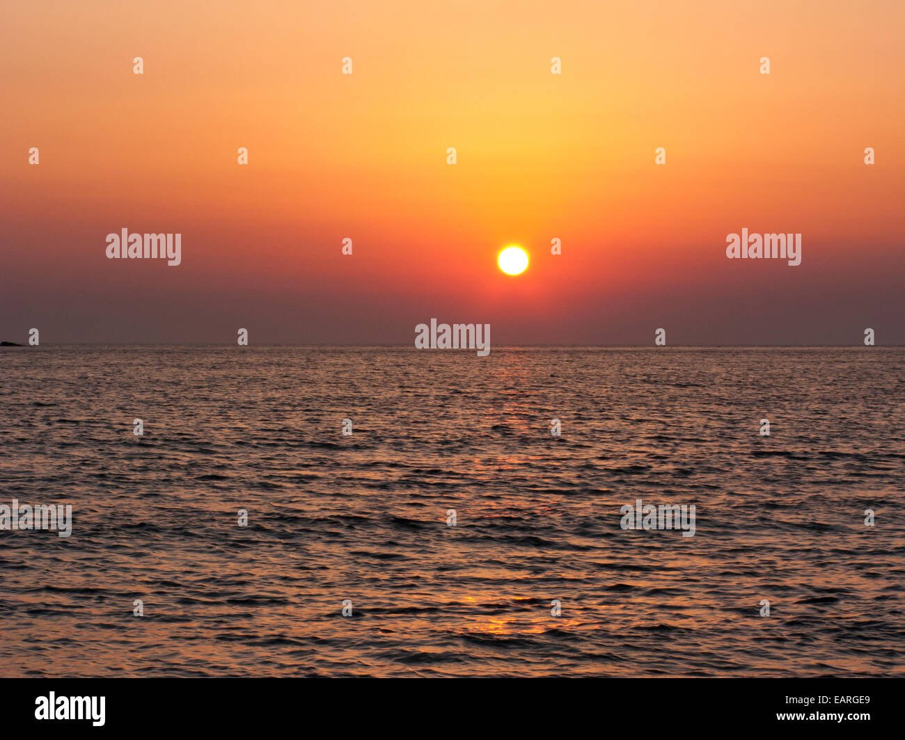 Spectacular sunset over calm water in Crete, Greece Stock Photo - Alamy