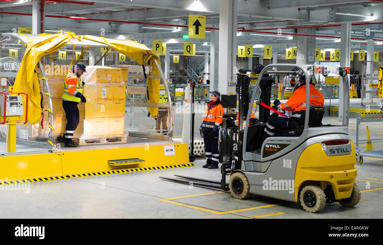 Schkeuditz, Germany. 20th Nov, 2014. Staff members of DHL, a division ...
