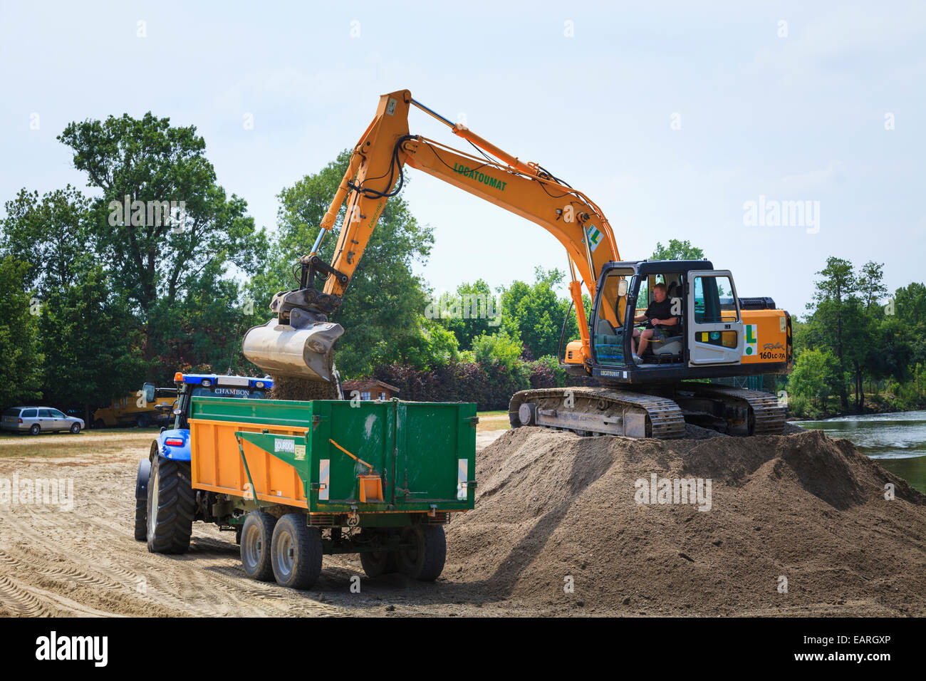 Excavator loading trailer hi-res stock photography and images - Alamy