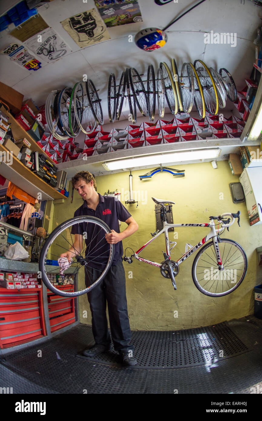 A worker adjusting repairing mending bike at Summit Cycles, small ...