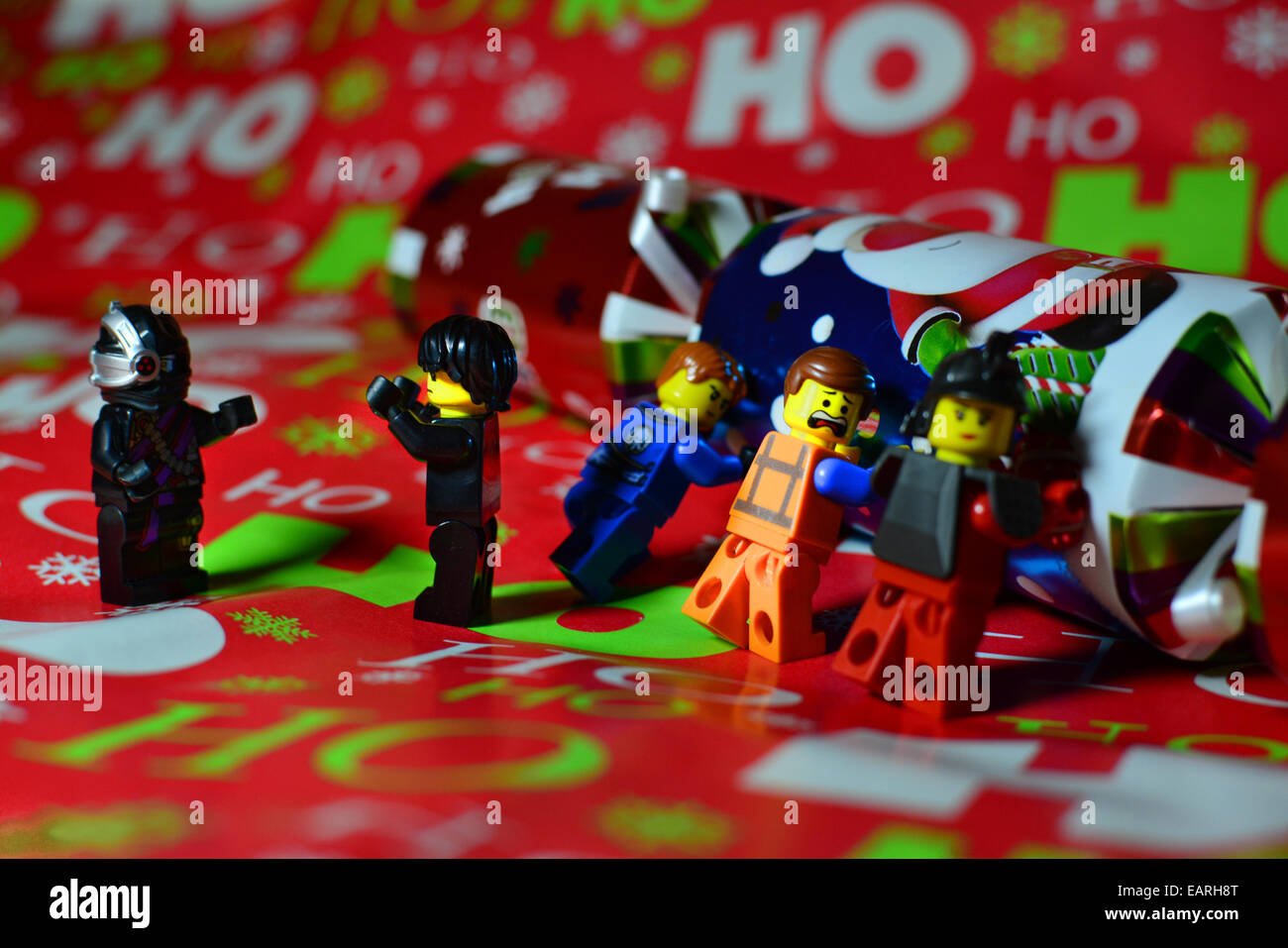 Lego figures pushing a Christmas cracker Stock Photo - Alamy