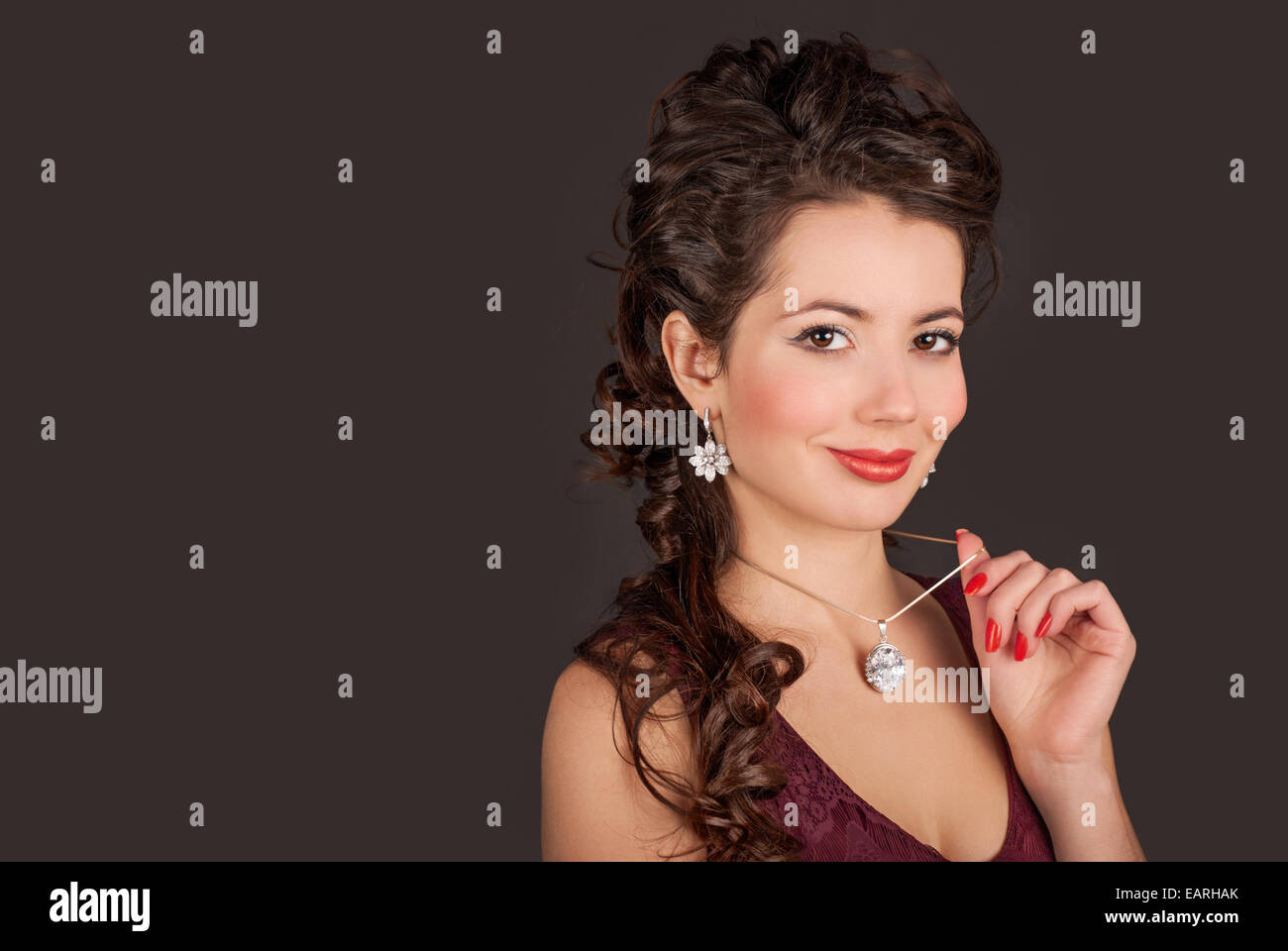 Glamorous woman in jewelry, pendants and earrings Stock Photo - Alamy