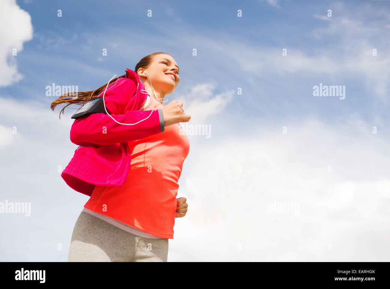 Running young woman smartphone hi-res stock photography and images - Alamy