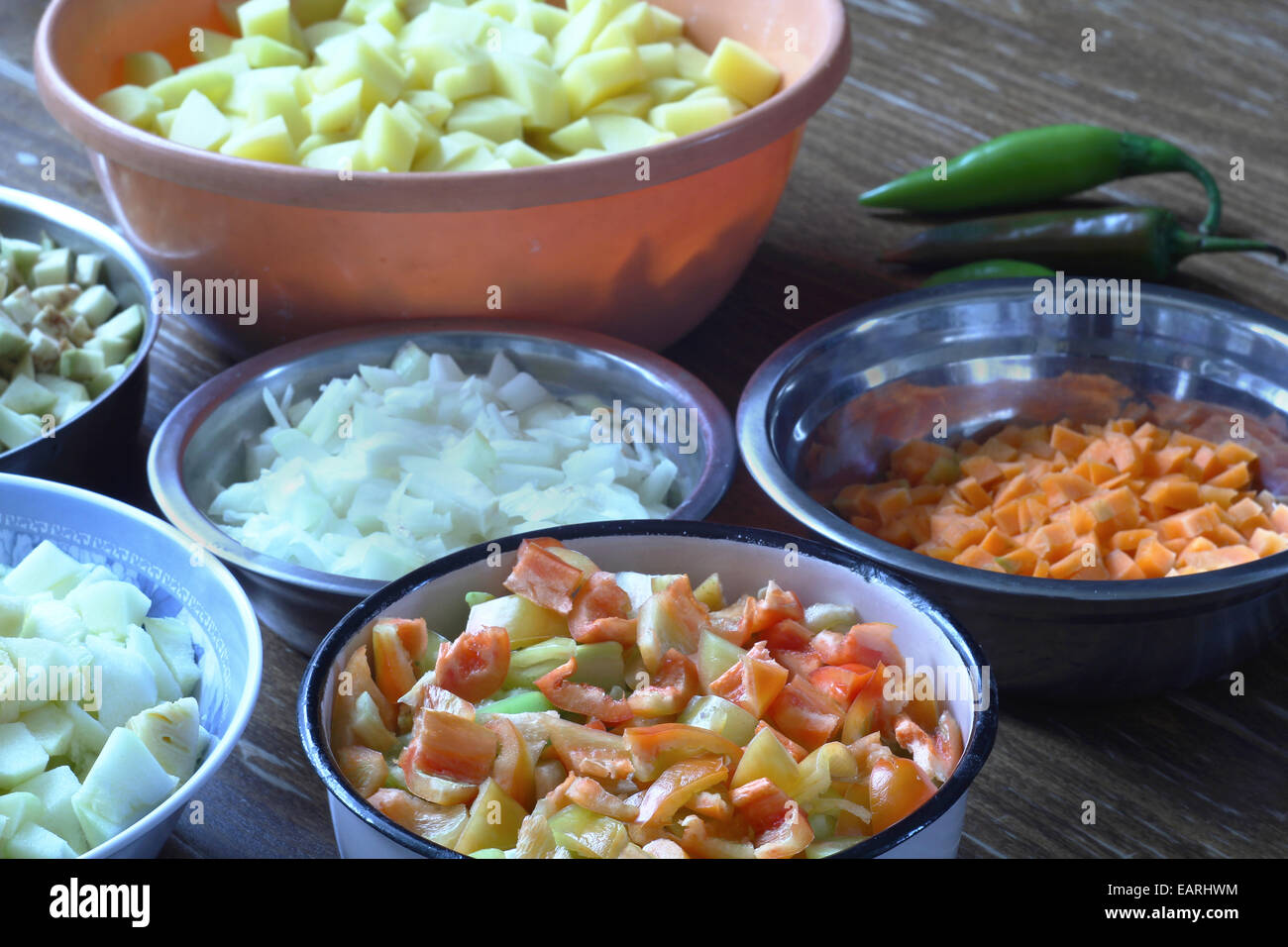 cut fruits and vegetables on wooden table Stock Photo - Alamy