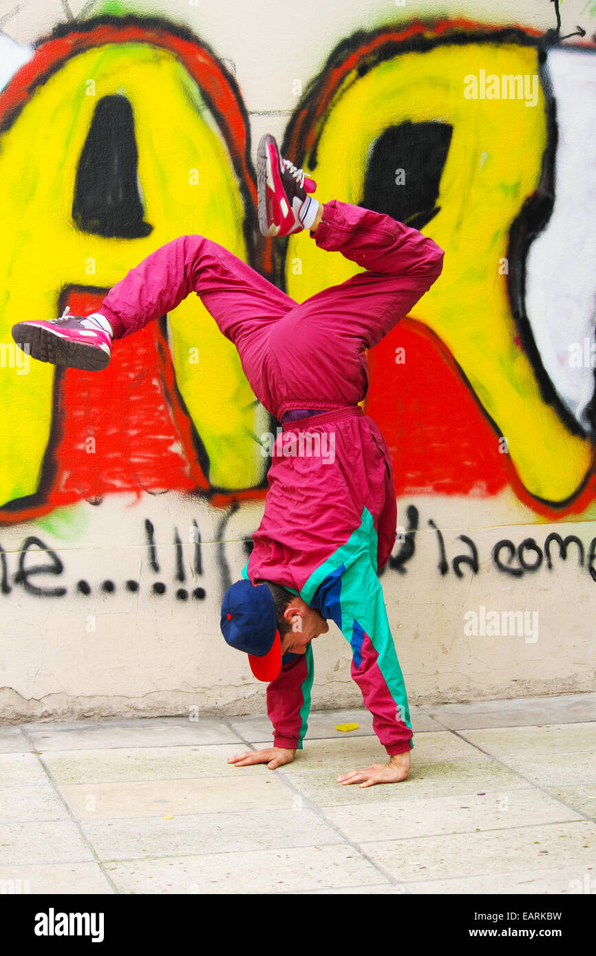 A colorful performing hip-hop dancer in front of a graffiti wall Stock ...