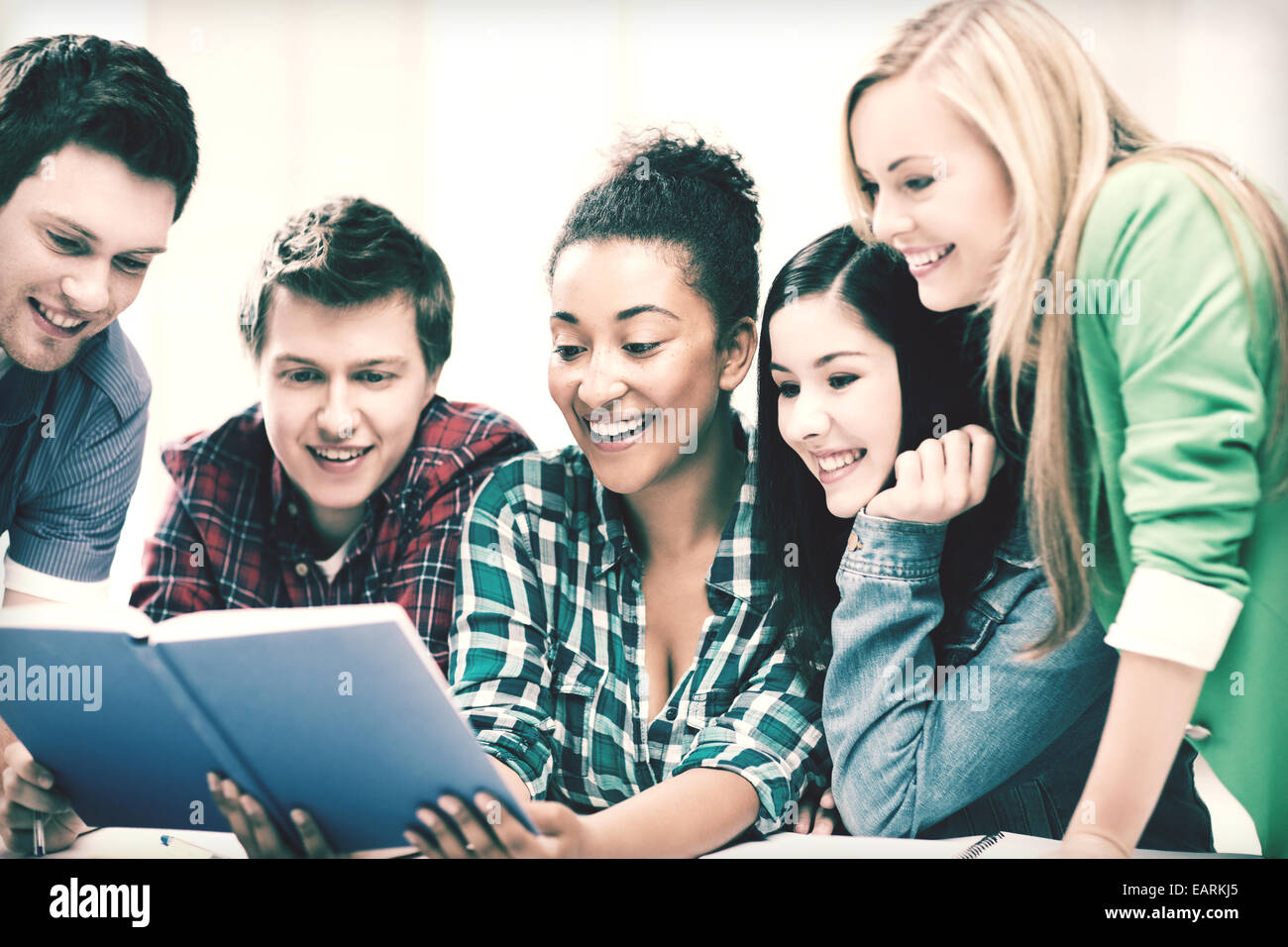 students reading book at school Stock Photo - Alamy