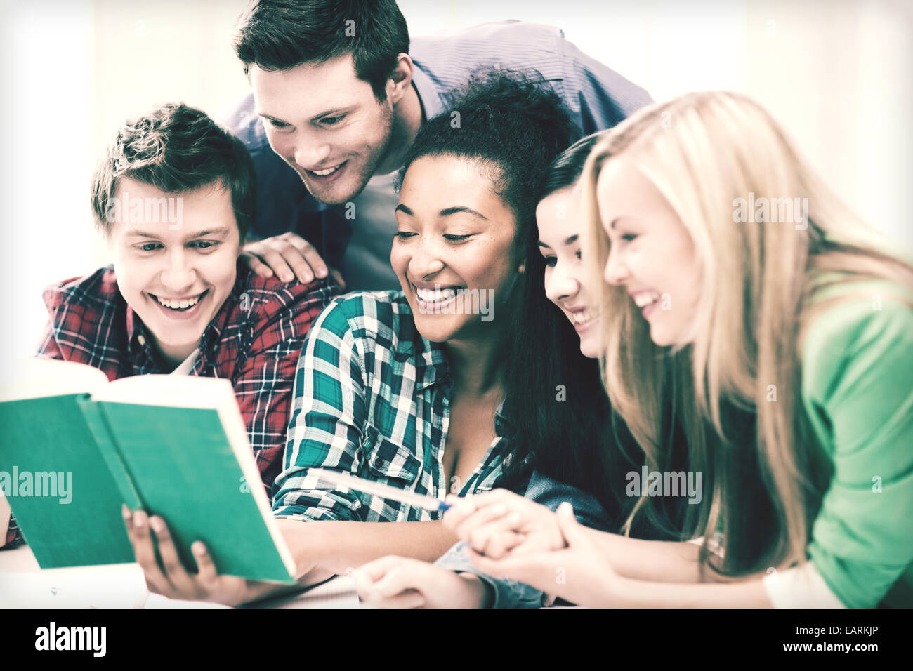 students reading book at school Stock Photo - Alamy