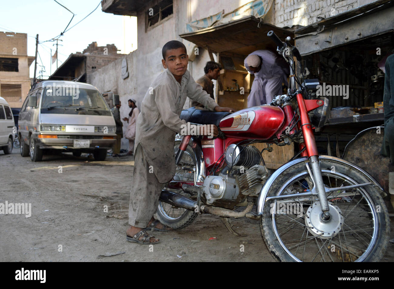 Quetta. 20th Nov, 2014. A Pakistani boy repairs a motorbike at a ...
