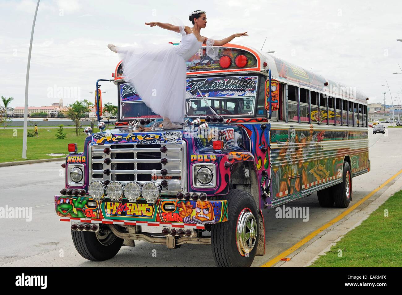 A ballerina balancing on top of a classical 'Red Devil' bus Stock Photo ...