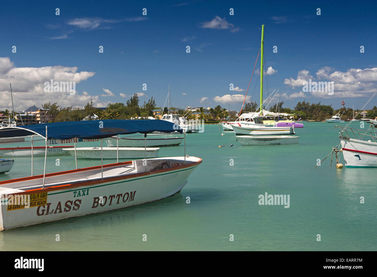 Mauritius, Grand Baie, public beach, glass bottom boat moored in ...