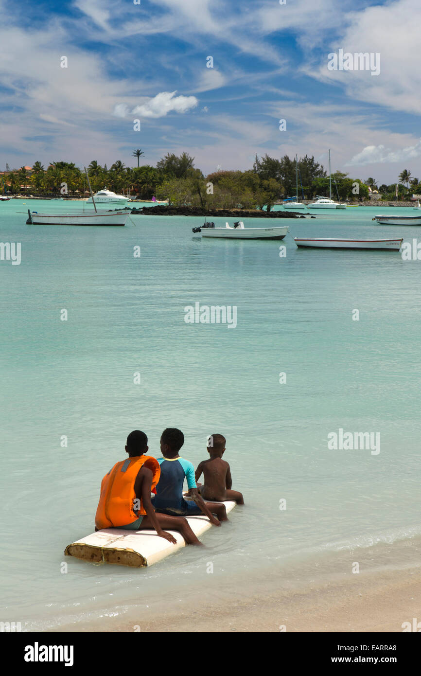 Mauritius, Grand Baie, public beach, three local boys playing on ...