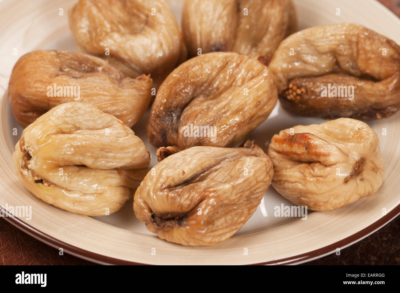 Sun dried figs on a plate on timber board Stock Photo - Alamy