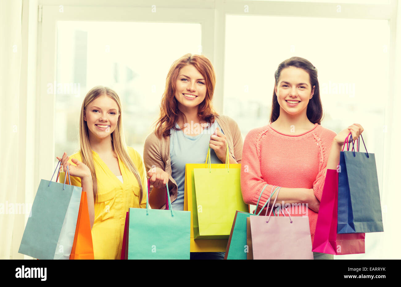 Three girlfriends with shopping bags hi-res stock photography and ...