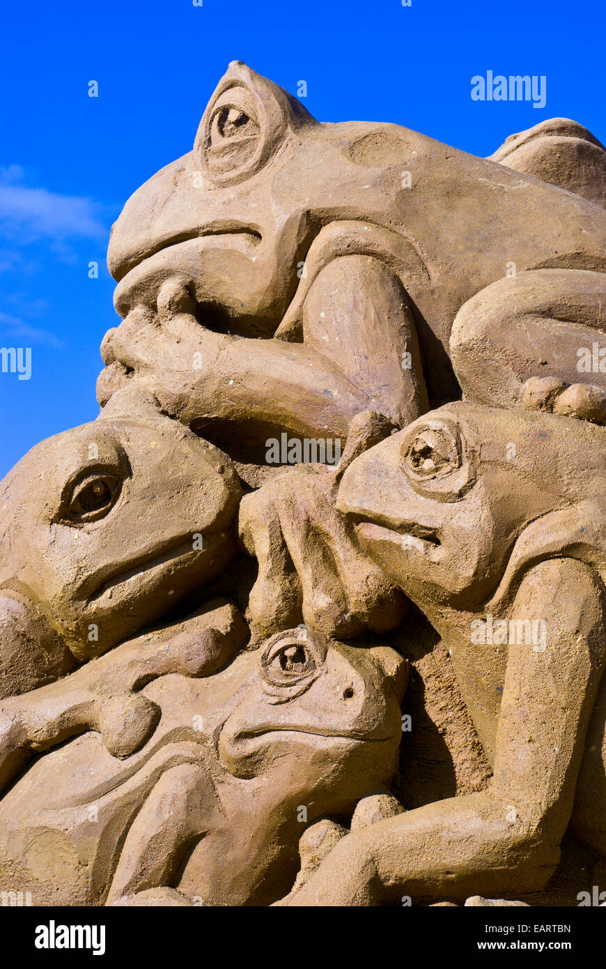 A professional sand sculpture featuring a pile of Green Tree Frogs ...