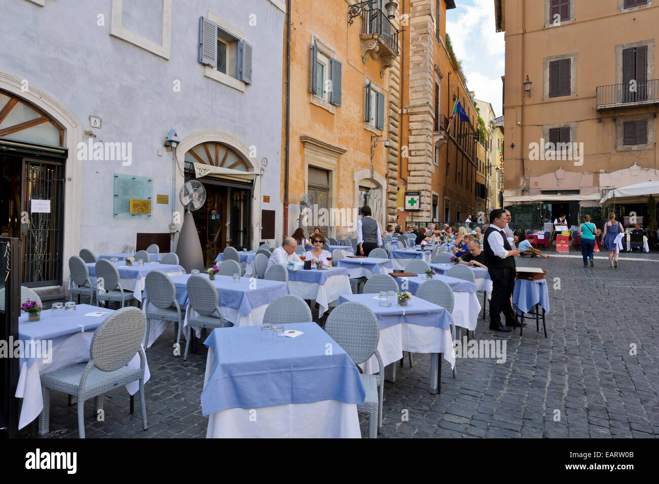 People dining in traditional restaurants in narrow street in the City ...