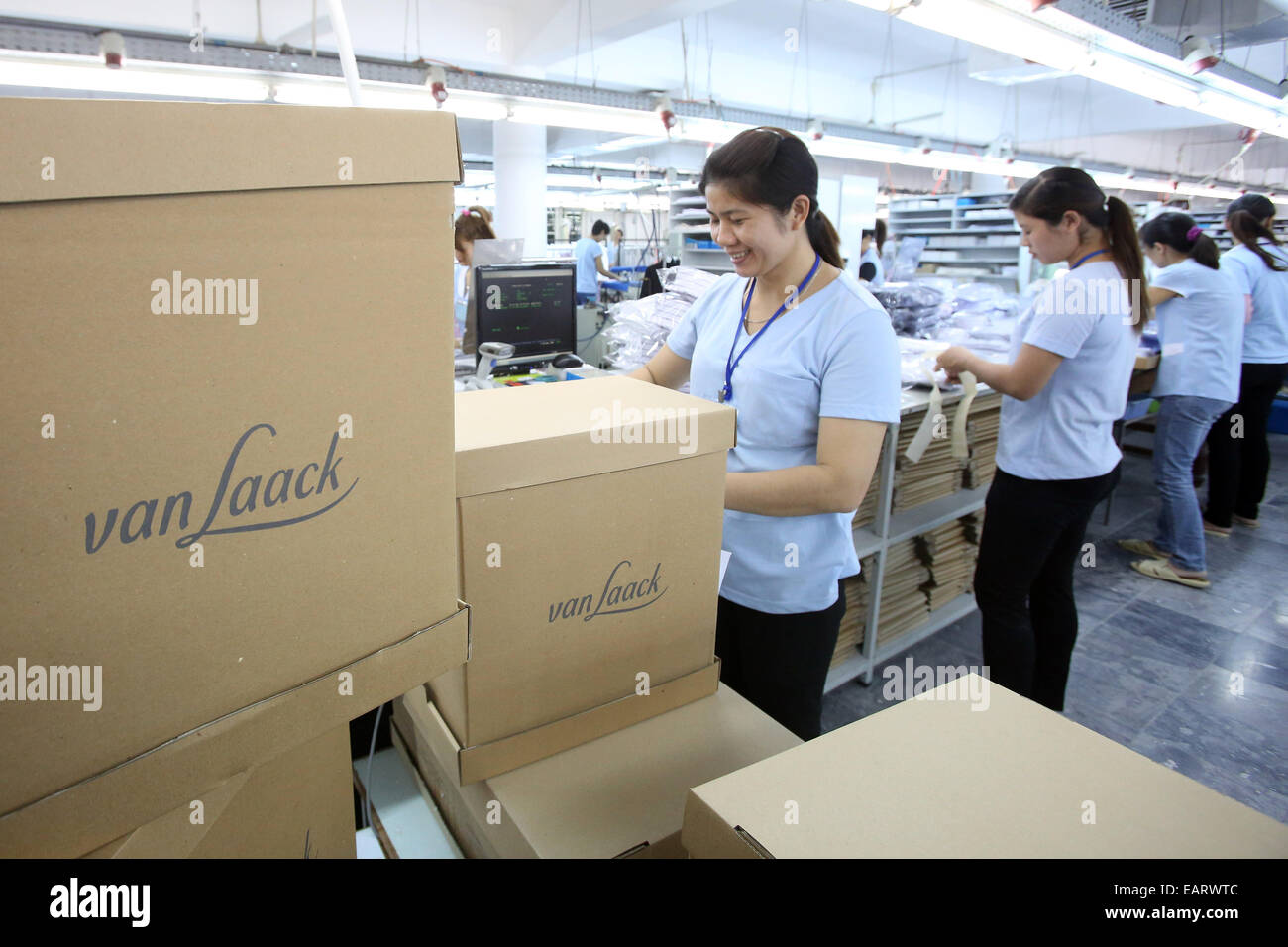 Hanoi, Vietnam. 20th Nov, 2014. Shirts are packed into boxes at a ...