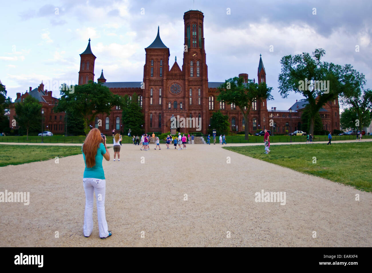 A tourist photographs the facade of the The Smithsonian Castle Stock ...