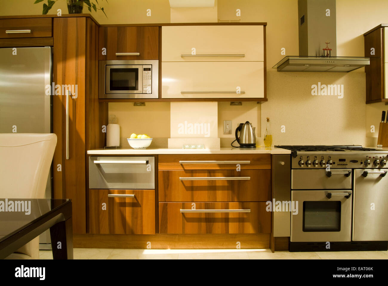 Modern kitchen with wooden units and range oven Stock Photo - Alamy