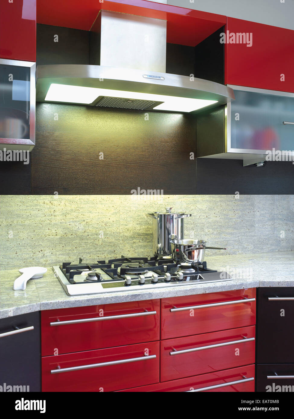 Hob set in worktop in red and black kitchen with fitted units Stock ...