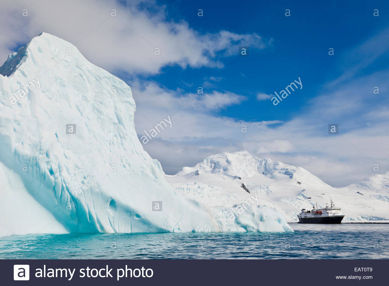 A cruise ship passes an iceberg Stock Photo - Alamy