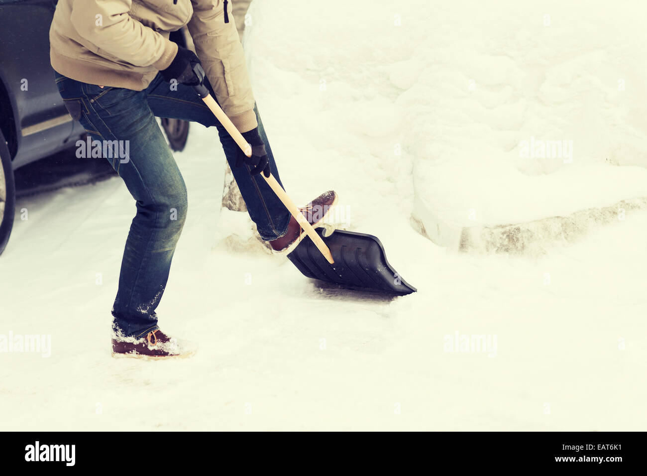 closeup of man shoveling snow from driveway Stock Photo - Alamy
