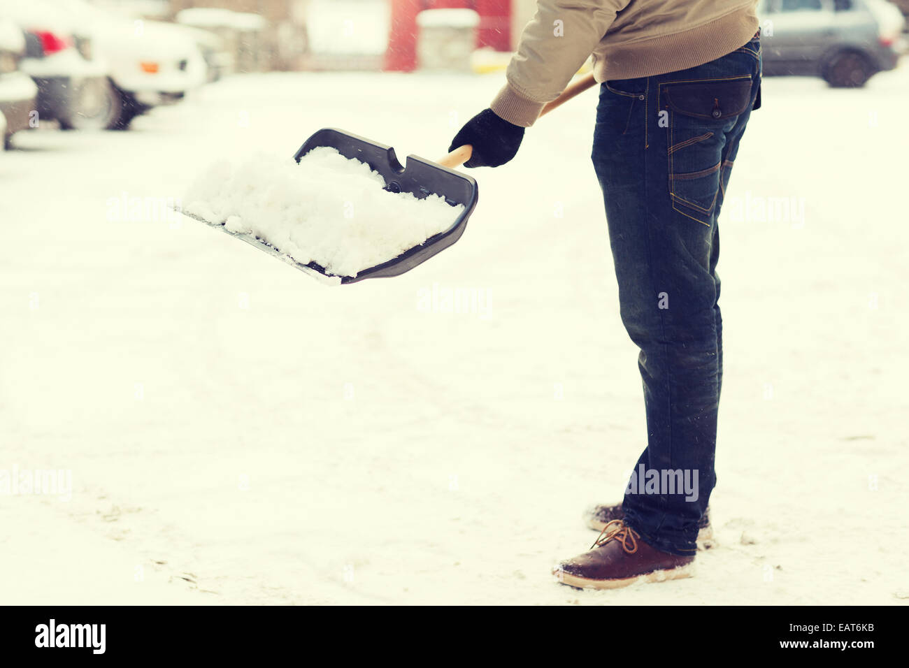 closeup of man shoveling snow from driveway Stock Photo - Alamy