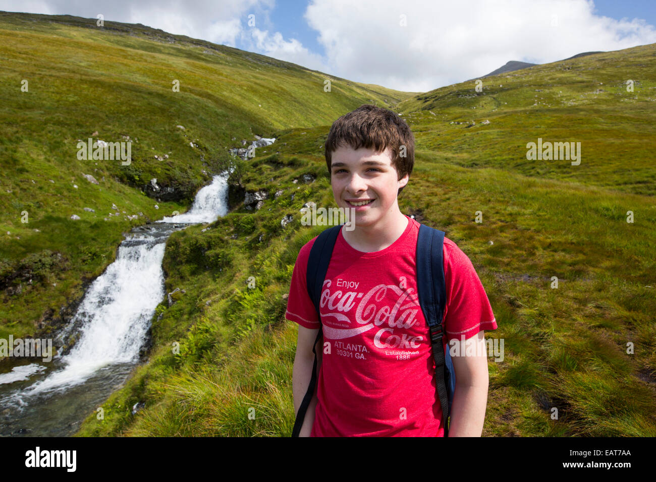 A teenage boy climbing Ben More, a Munro on the Isle of Mull, Scotland ...