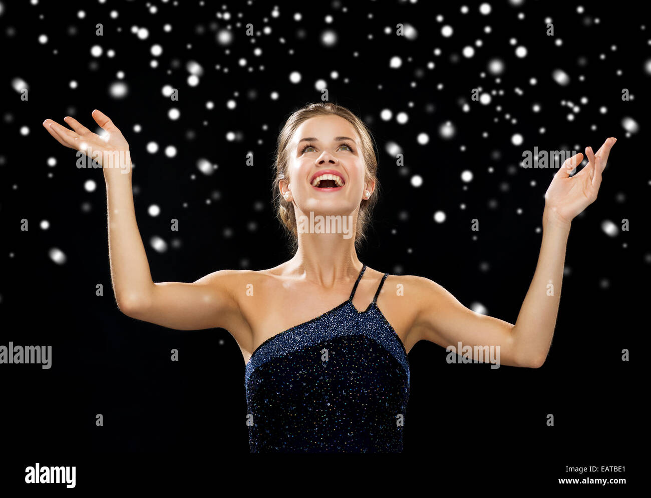 smiling woman raising hands and looking up Stock Photo - Alamy
