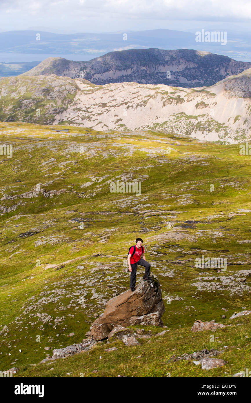 A teenager climbing the Munro on Ben More, Isle of Mull, Scotland, UK ...