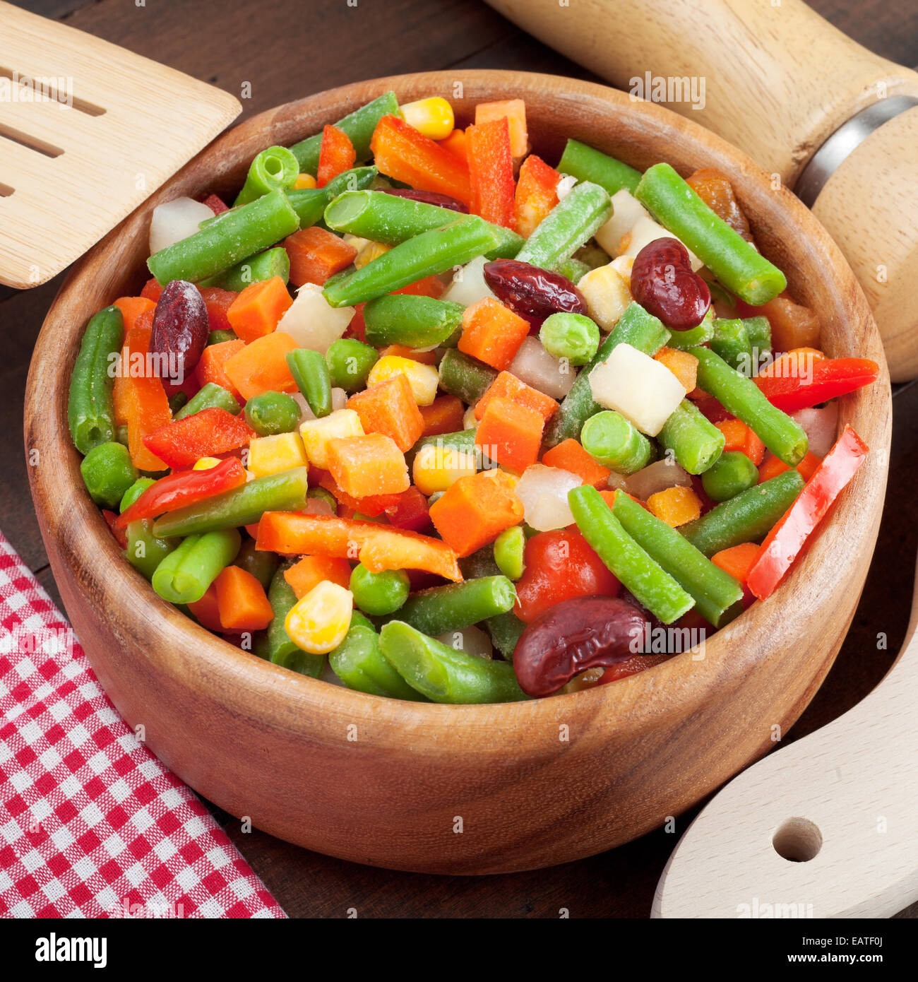mixed vegetables in wooden bowl on kitchen table Stock Photo - Alamy