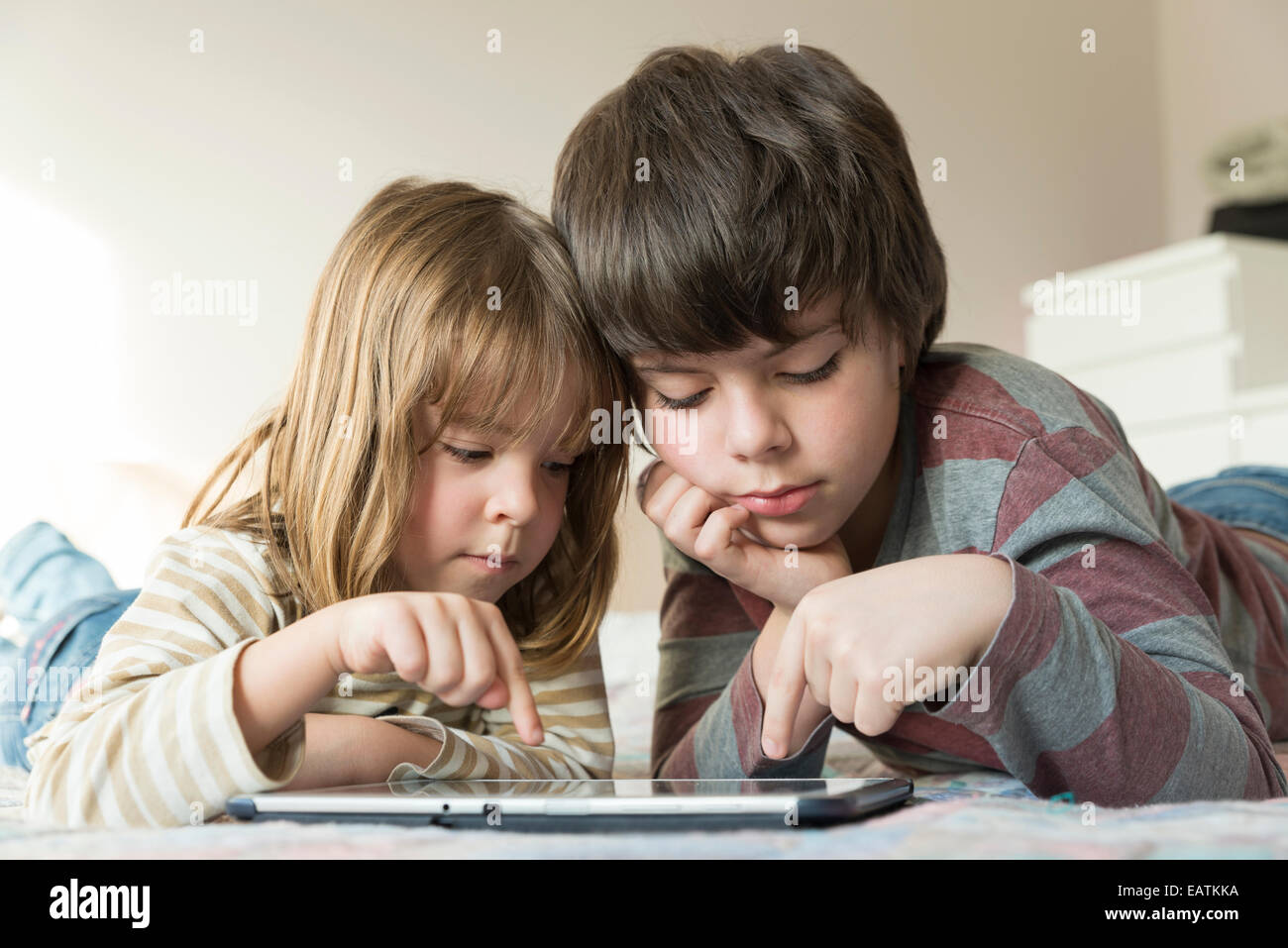 Child playing on a tab hi-res stock photography and images - Alamy