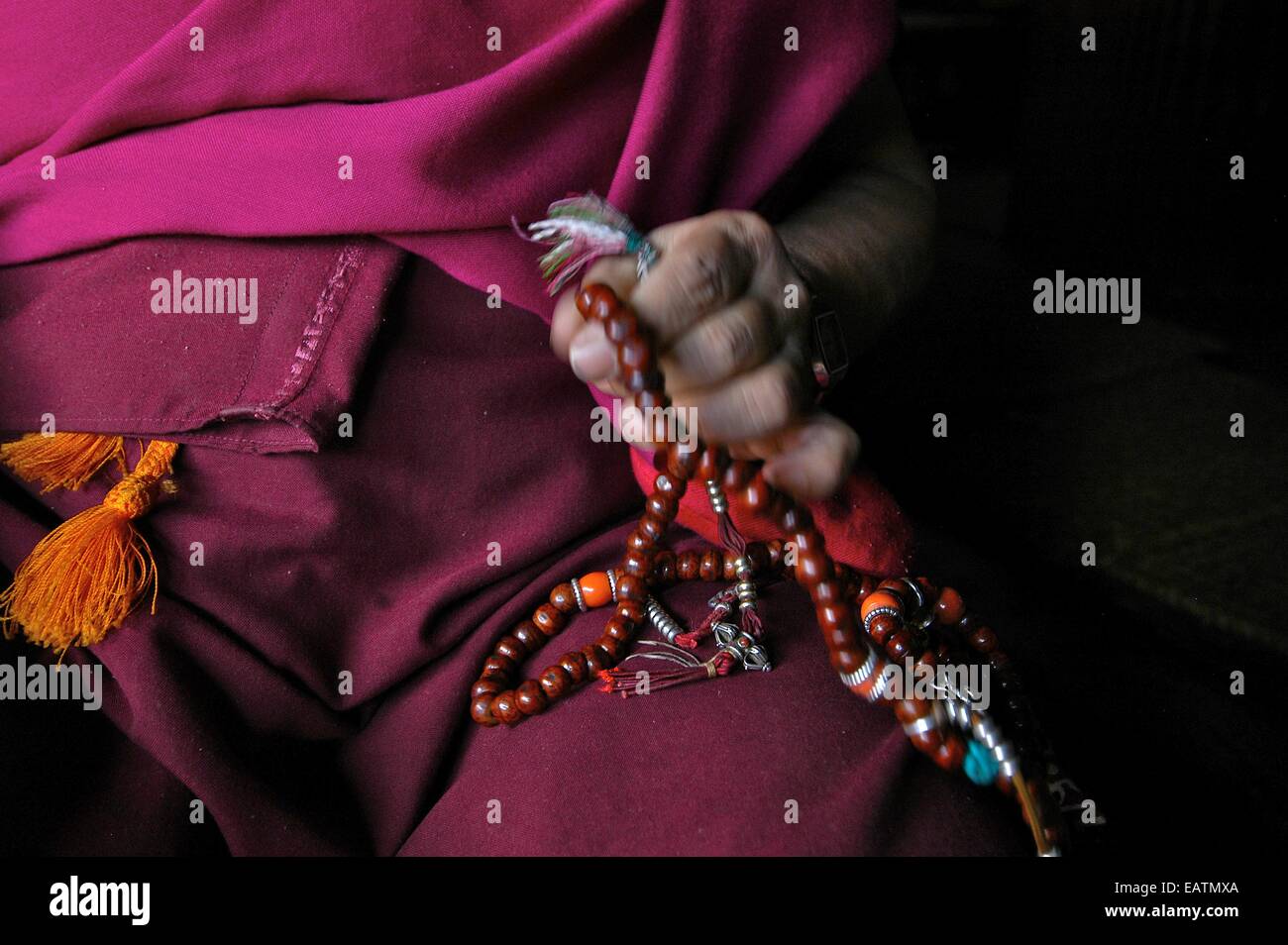 Prayer beads in a monk's hand Stock Photo - Alamy
