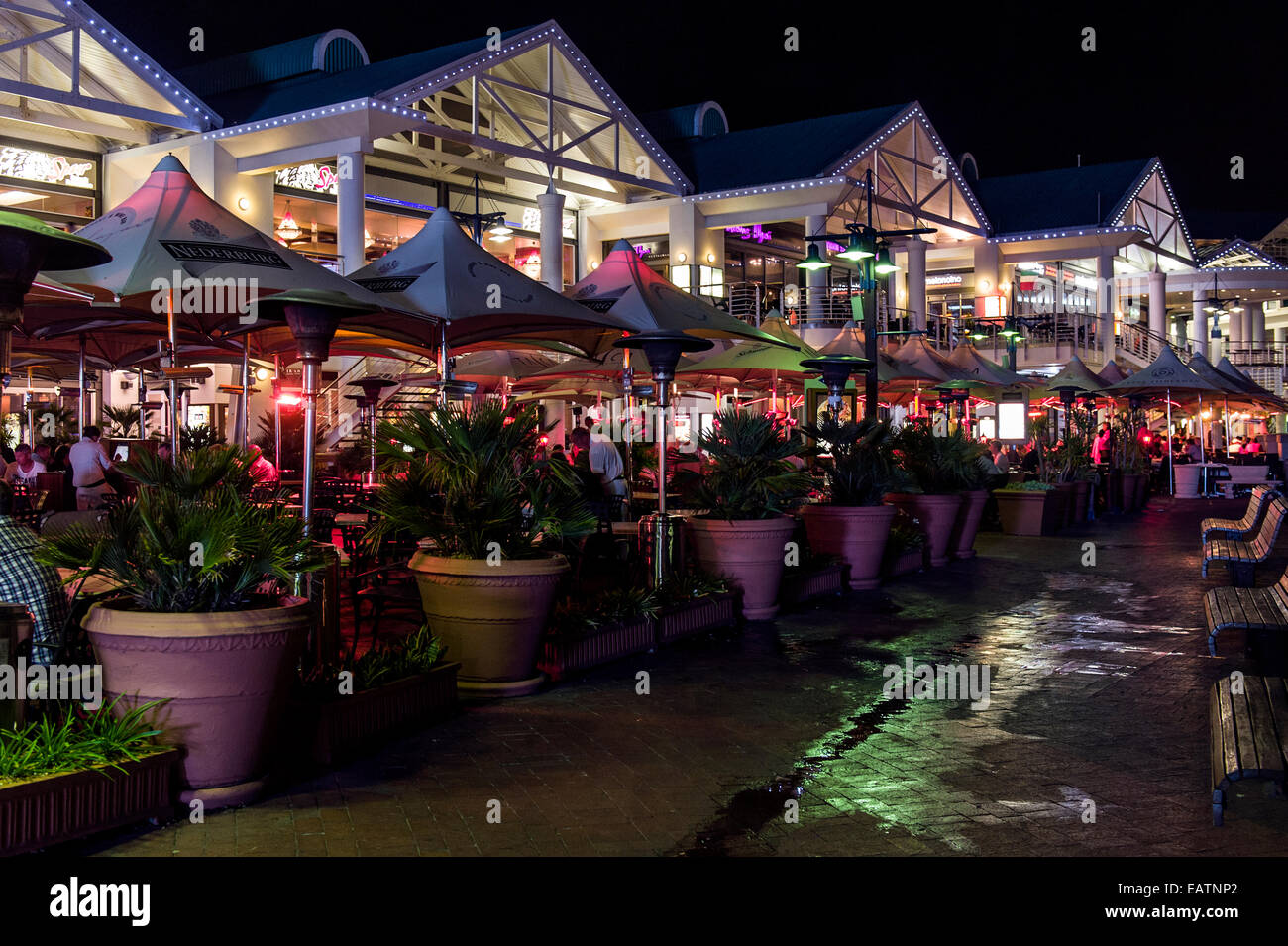 Restaurants and cafes line the foreshore of a marina shopping zone ...