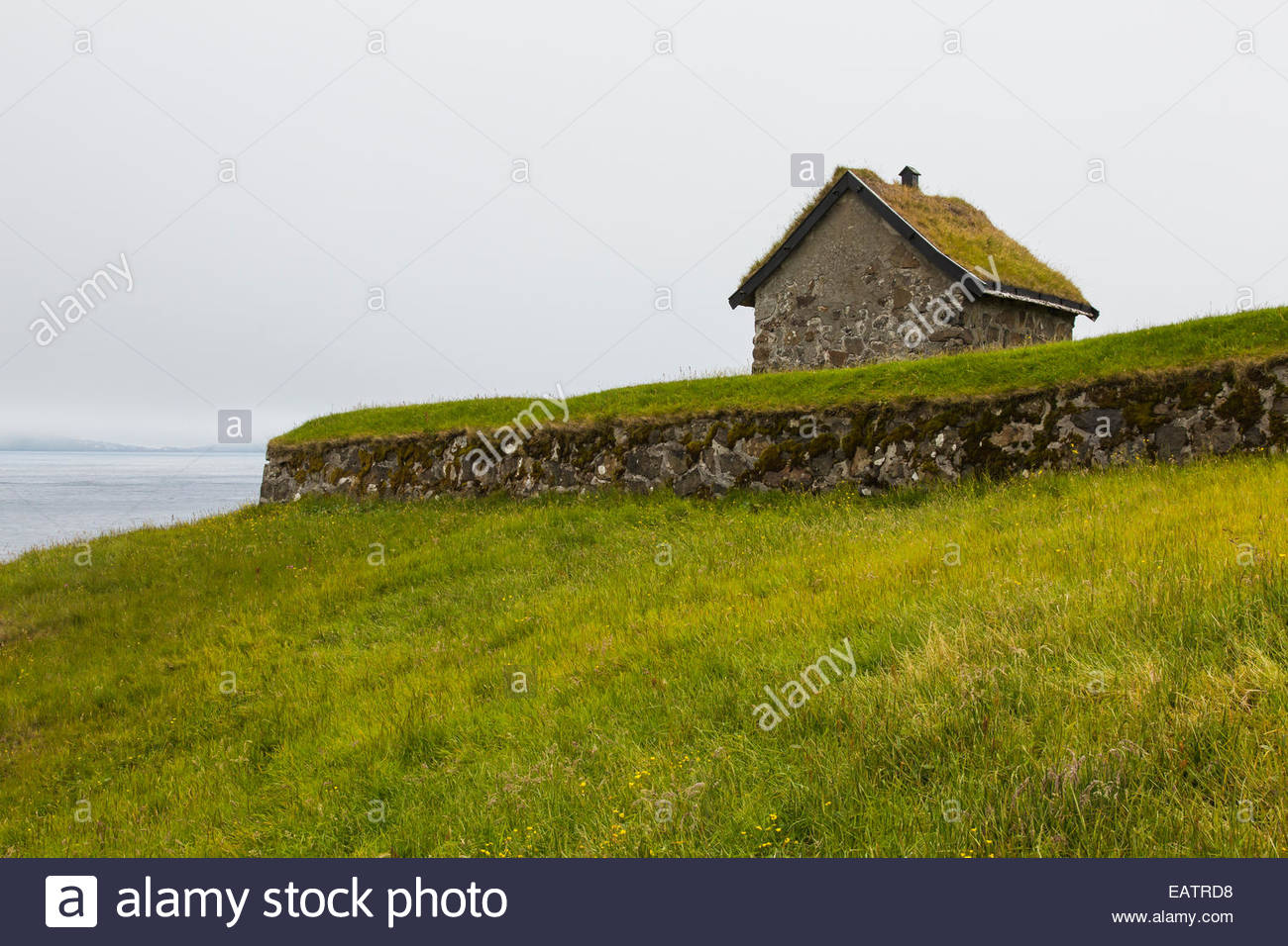 A traditional sod roof house overlooks the Atlantic Ocean Stock Photo ...