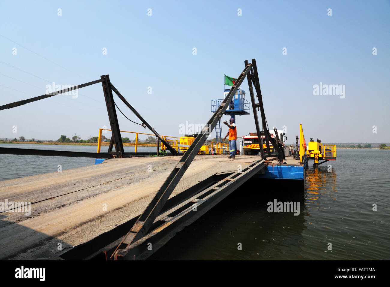 An African vehicular ferry with trucks, bicycles and pedestrians ...