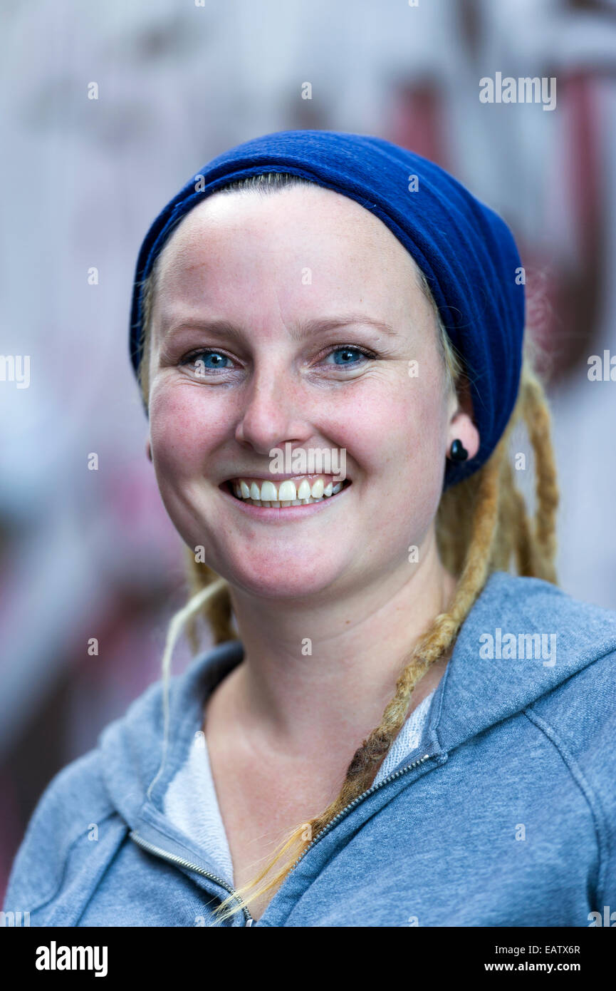 A healthy young woman with dreadlocks smiles at the camera Stock Photo ...