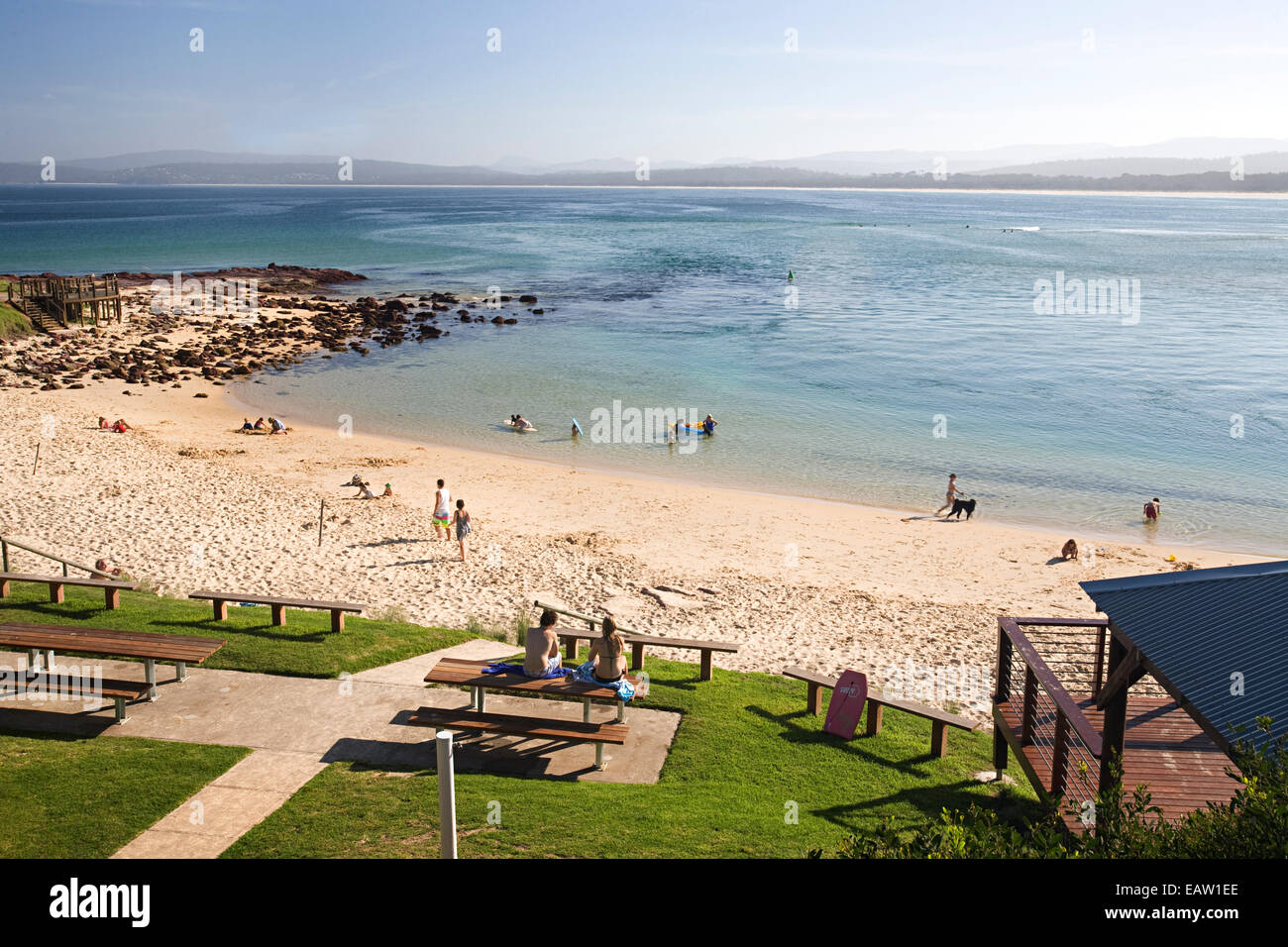 People relaxing on a small white sand beach with crystal blue water at ...