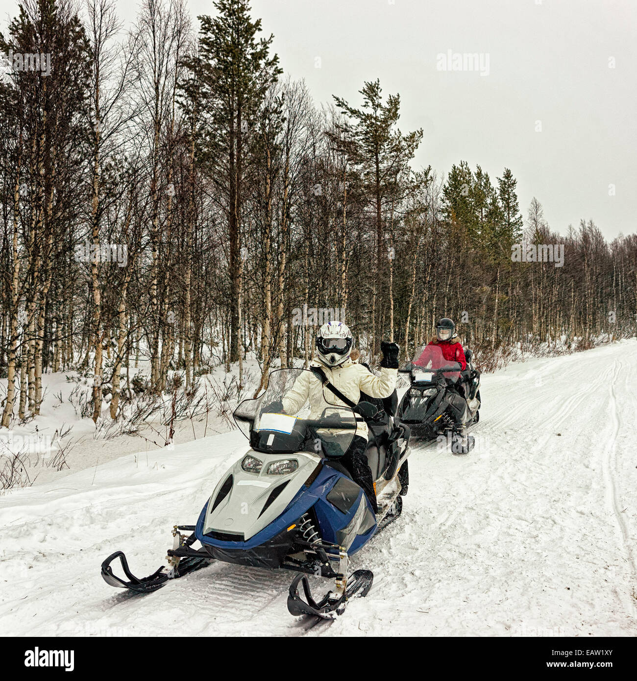 Two girls on the snowmobiles Stock Photo - Alamy