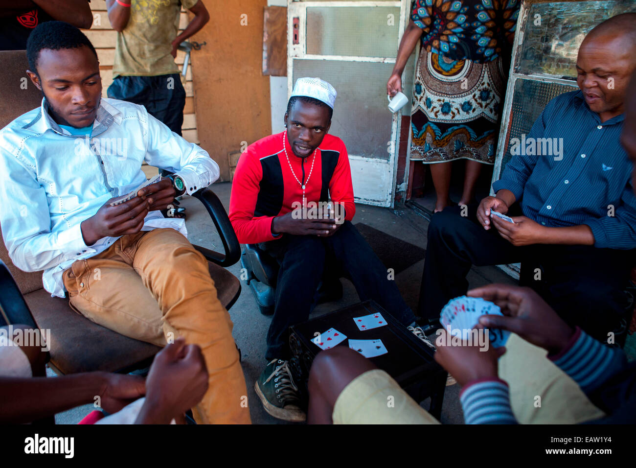 A group of men play casino at Skomplaas hostel one of Durban Deep ...