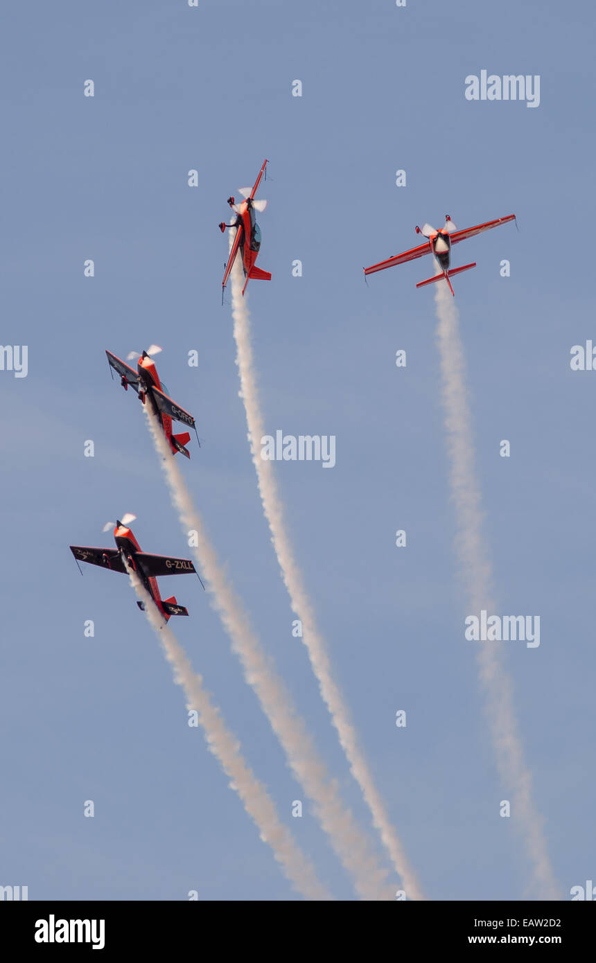 The Blades Aerobatic Display Team roll in formation during a maneuver ...