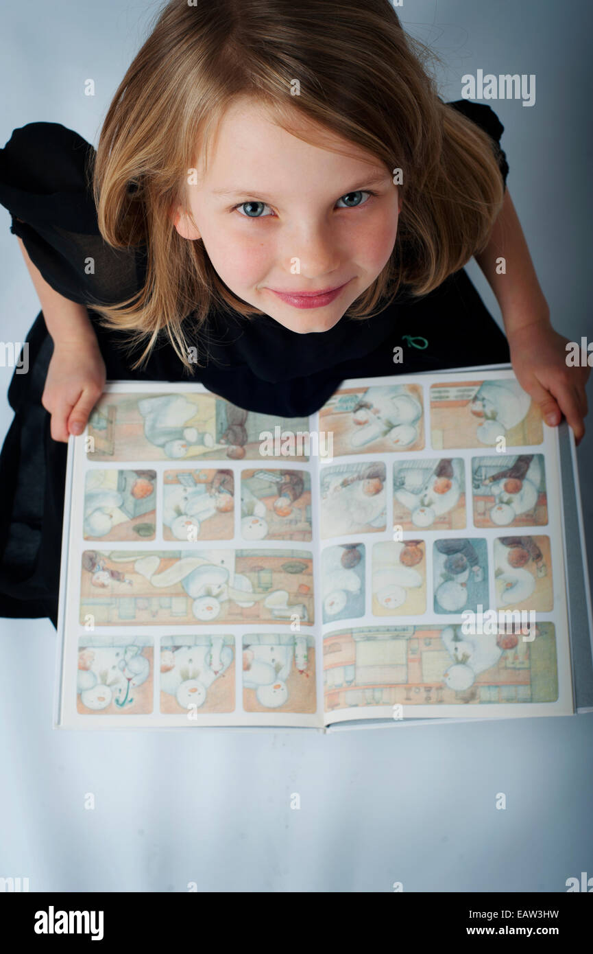 A happy girl reading colorful book Stock Photo - Alamy