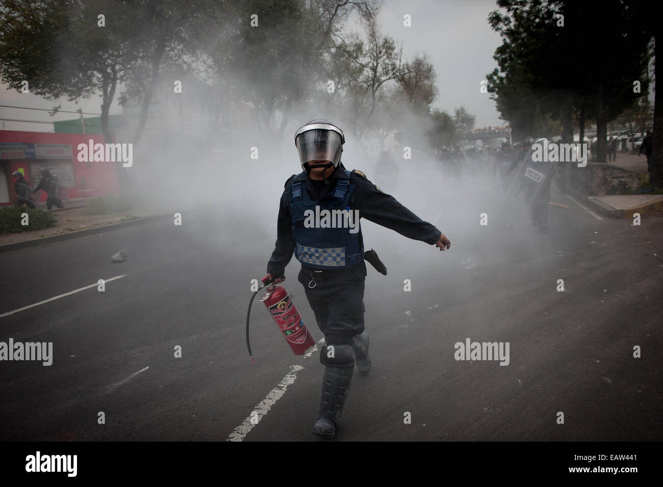 Mexico City, Mexico. 20th November, 2014. A riot policeman runs with a ...