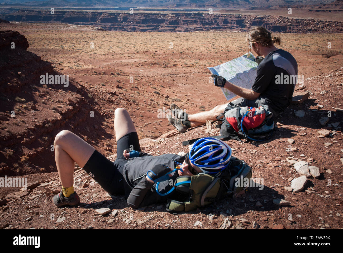 Mountain bikers consult their topo maps while touring the White Rim ...